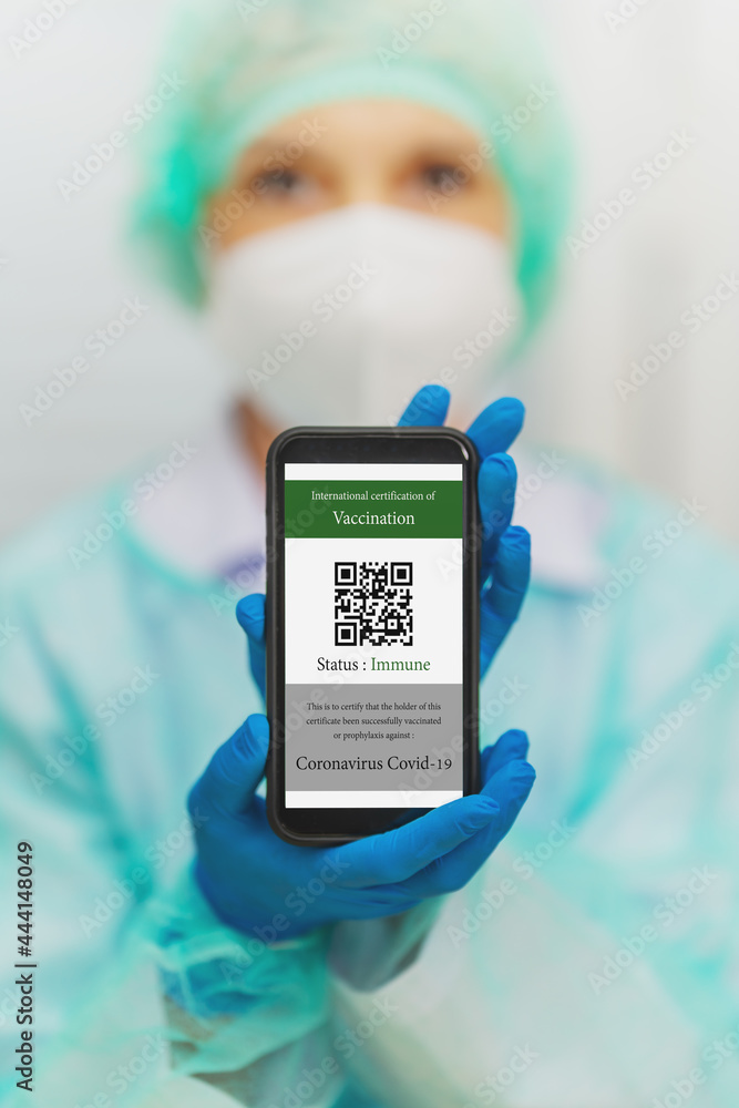 digital covid-19 vaccination certificate with QR code on smartphone ...