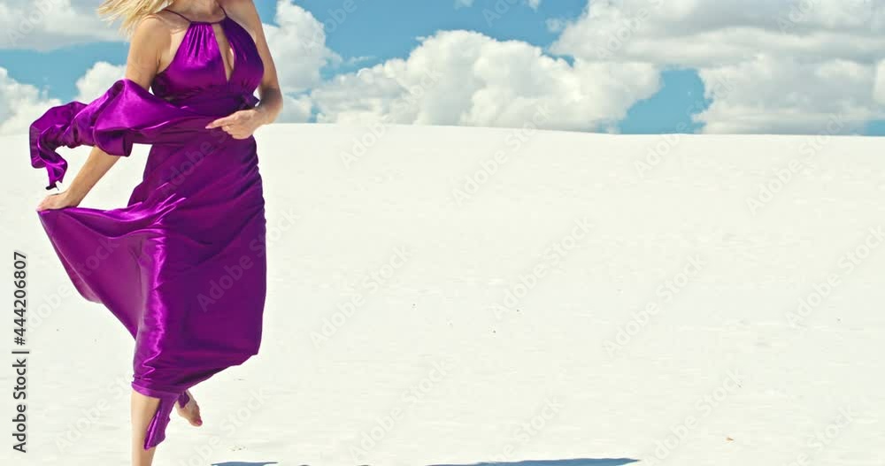 Cinematic slow motion of a woman walking on a sand dune. Barefoot woman ...