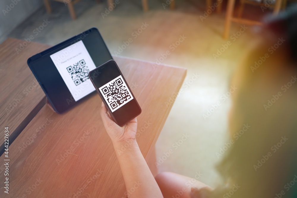 Qr code payment. Woman scanning QR code online shopping cashless ...