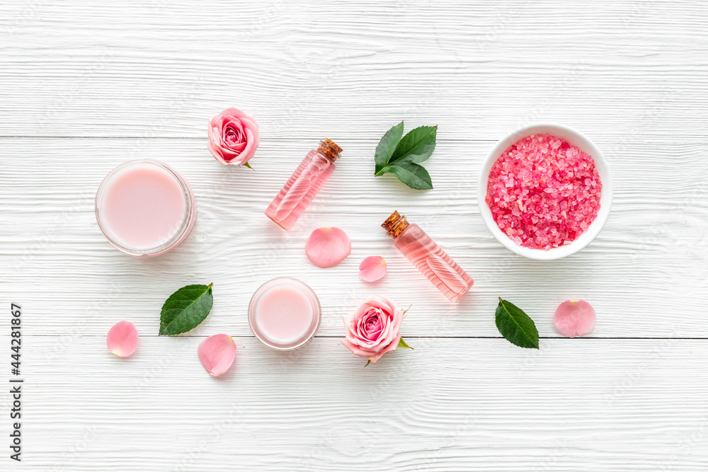 Cosmetics with rose oil essence. Face cream lotion and flowers, top ...