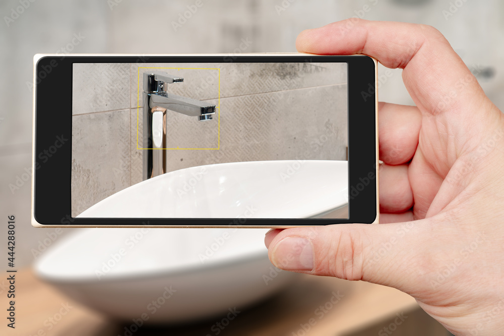 Water tap on smartphone screen. Water tap and sink in the bathroom. The ...