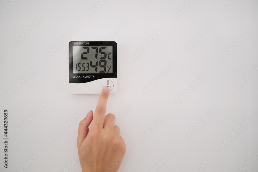 the girl adjusts the psychrometer at home. device for measuring ...