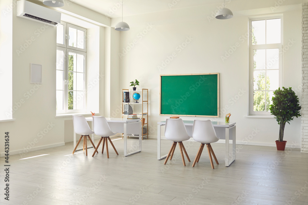 Modern empty classroom interior with desks, chairs and chalkboard ...
