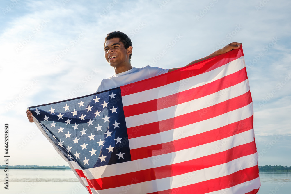 African American man looking at camera and proudly holding American ...