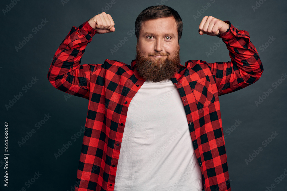 Sassy confident smiling macho man with big muscles, proudly pointing ...