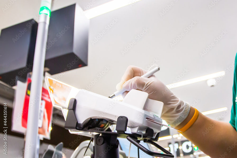 Selective focus to customer hand signing with electronic pen on a touch ...