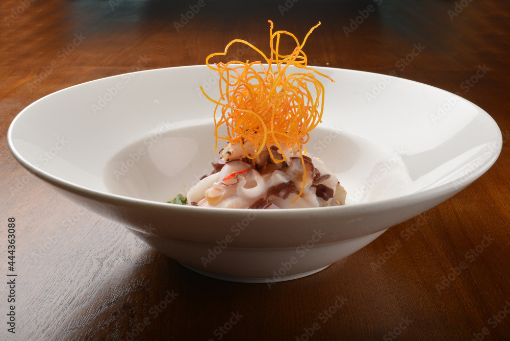 cold dish octopus sashimi salad with green vegetables and carrot ...