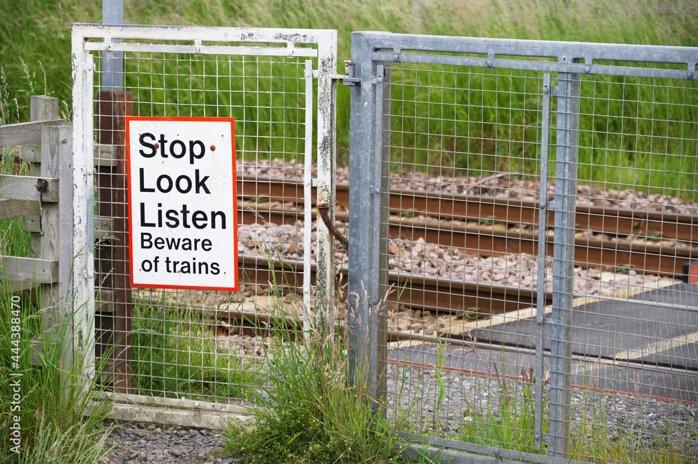 Stop look listen safety road sign at railway train station danger ...