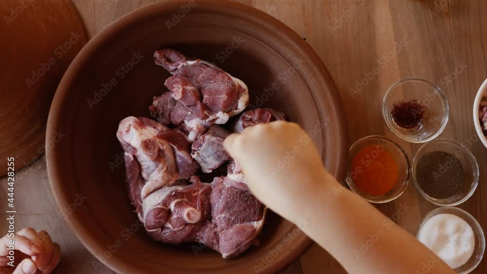 Cooking a lamb, mutton, sheep meat tajine, tagine in a Moroccan clay ...