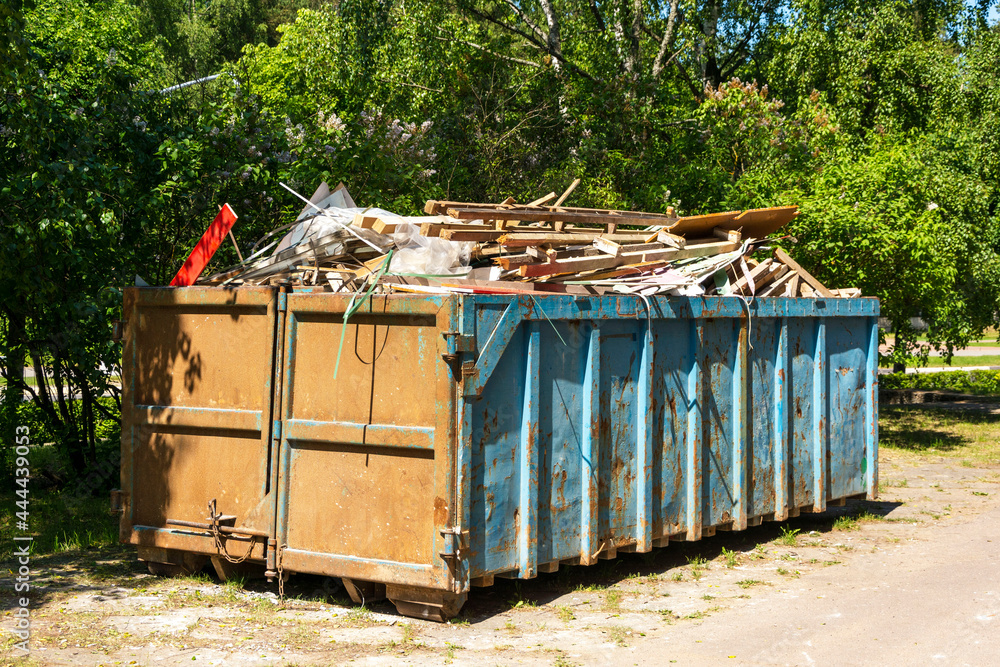 garbage container equipped for transportation by truck, filled with ...