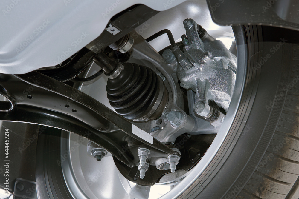 Modern car in a car service on a lift. Bottom view of the front ...