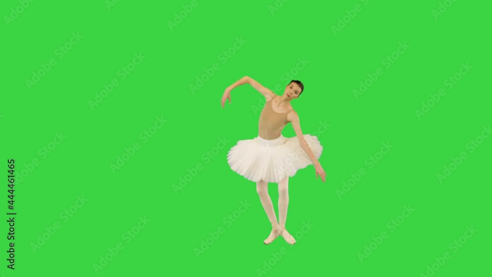 Young ballerina performing some ballet movements on a Green Screen ...