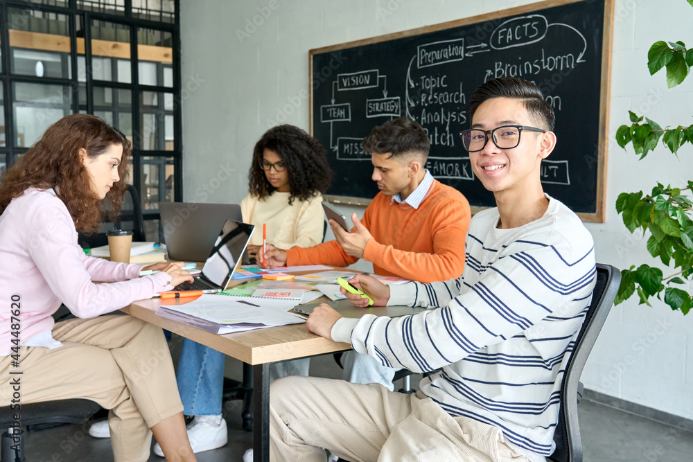 Asian guy student studying with diverse multiracial young happy ...