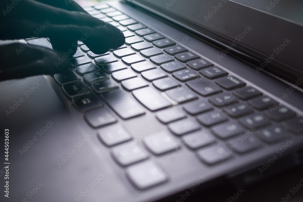 Blur image of finger typing keyboard laptop computer. hacker steal ...