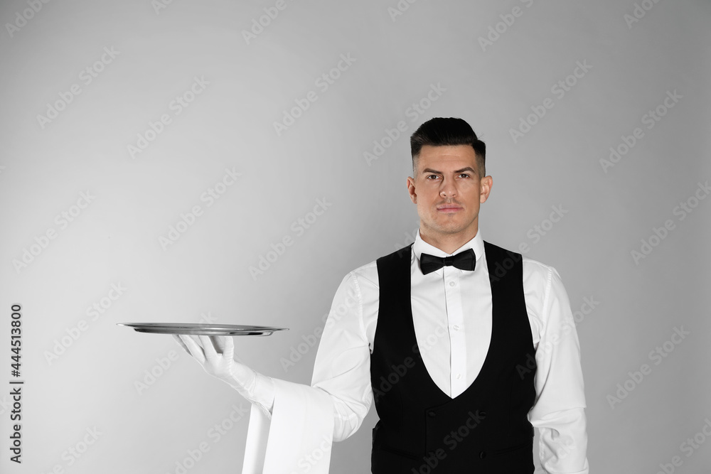 Handsome butler with tray on light grey background Stock Photo | Adobe ...