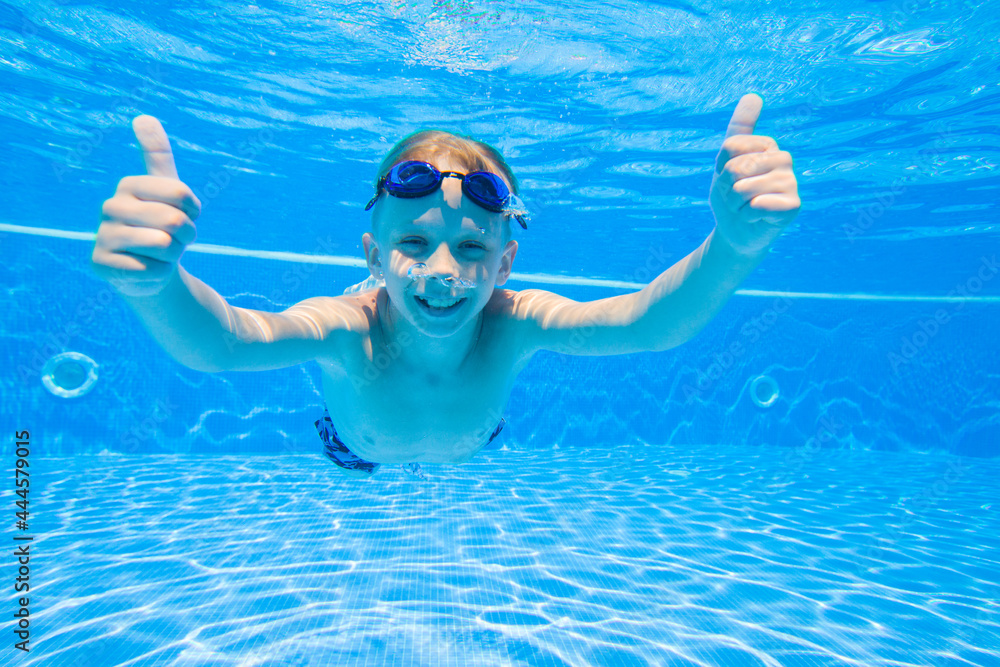 boy swimming in pool Stock Photo | Adobe Stock