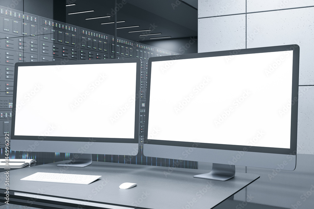 Close up of desktop with empty blank computer monitors in futuristic ...