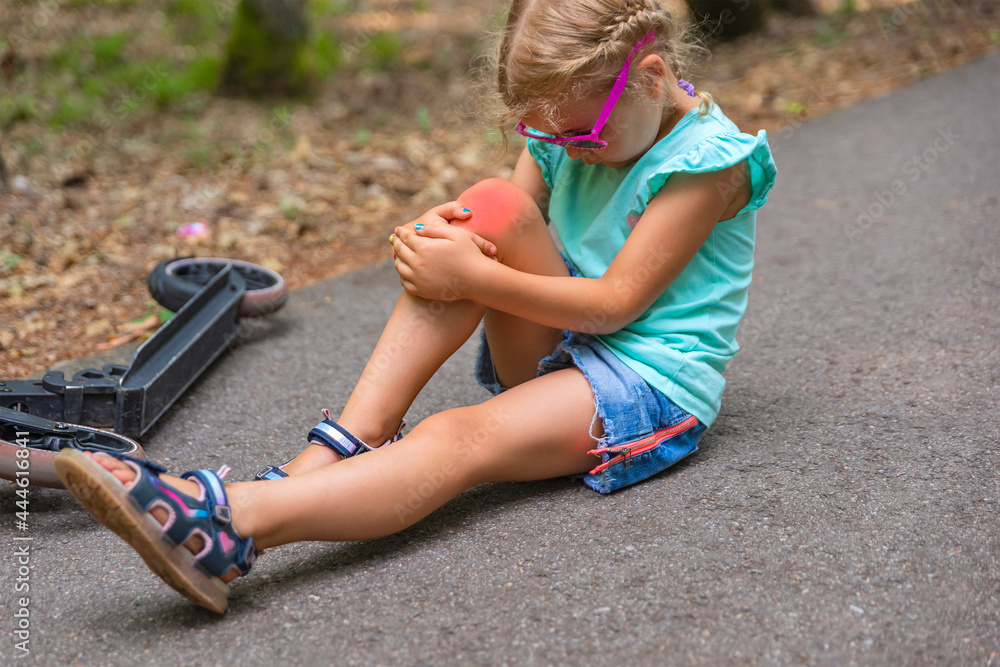 Trauma on scooter. A five-year-old girl fell on a scooter in a park and ...