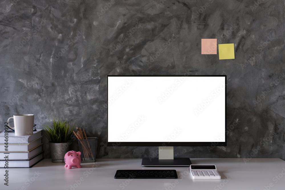 Front view of Mock up computer and office supplies gadget on desk ...
