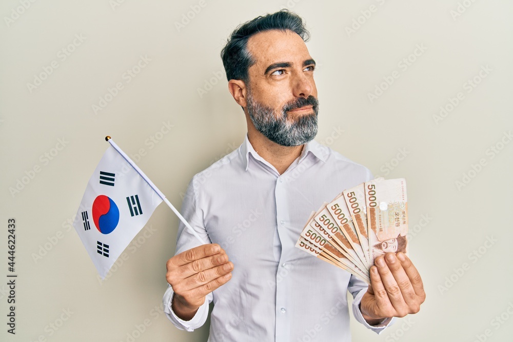Middle age man with beard and grey hair holding south korea flag and ...