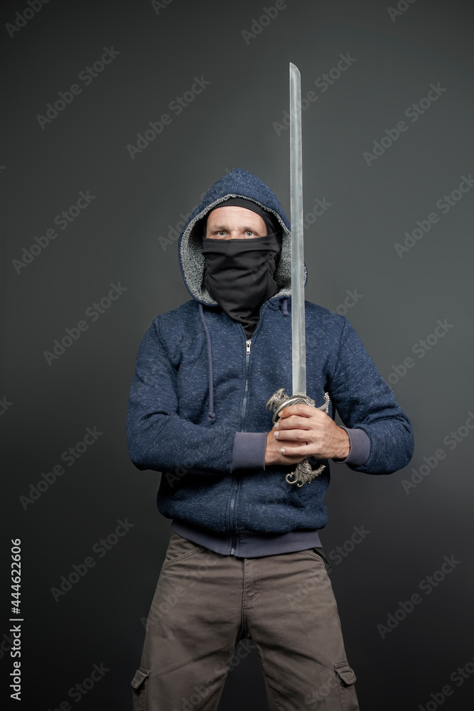 American Brutal man in a blue hoodie and black face mask with a Fantasy ...