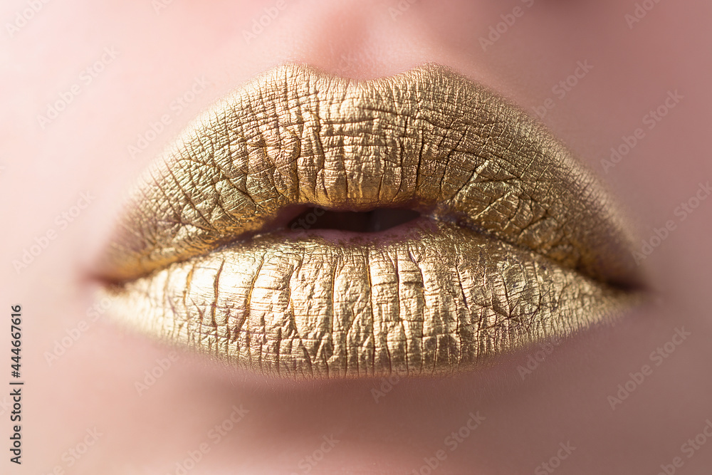 Sexy lips. Closeup sexy beautiful female golden lips isolated. Gold ...