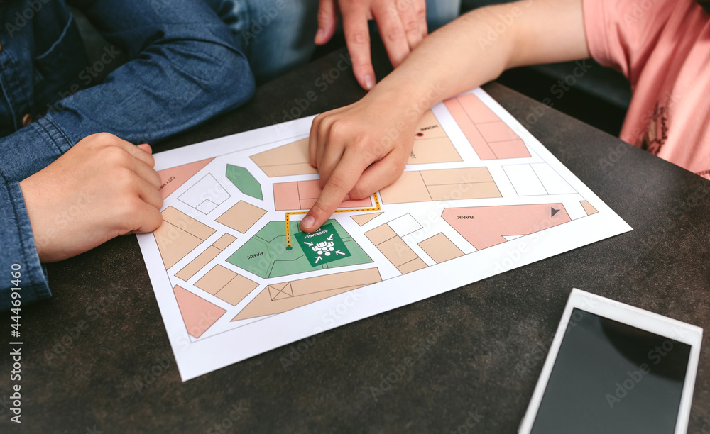 Unrecognizable family looking assembly point map at home Stock Photo ...