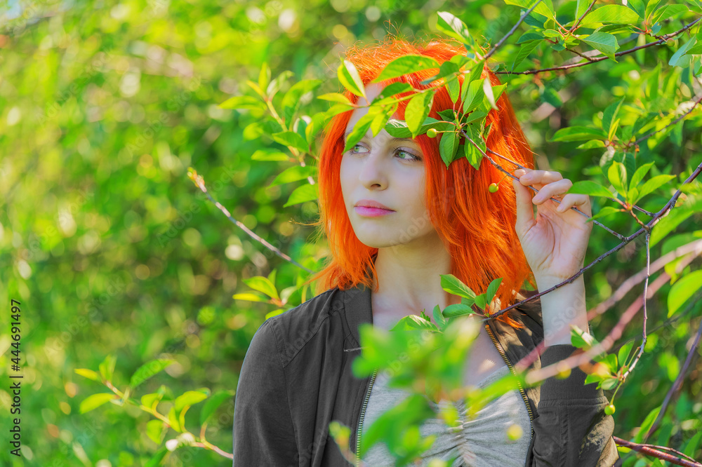Beautiful young woman among trees Stock Photo | Adobe Stock