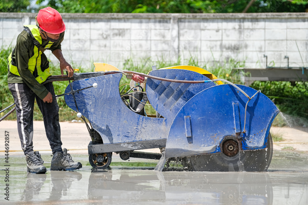 Worker contorl cutting machine are cutting concrete expansion and ...