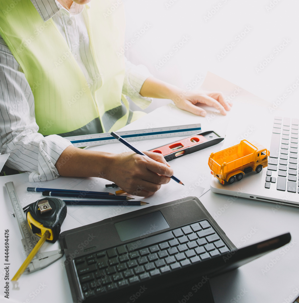 engineer working at a drawings of house in office for discussing ...