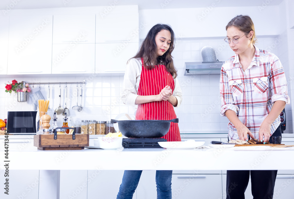 Attractive Two smile women is cooking in the modern kitchen, Two ...