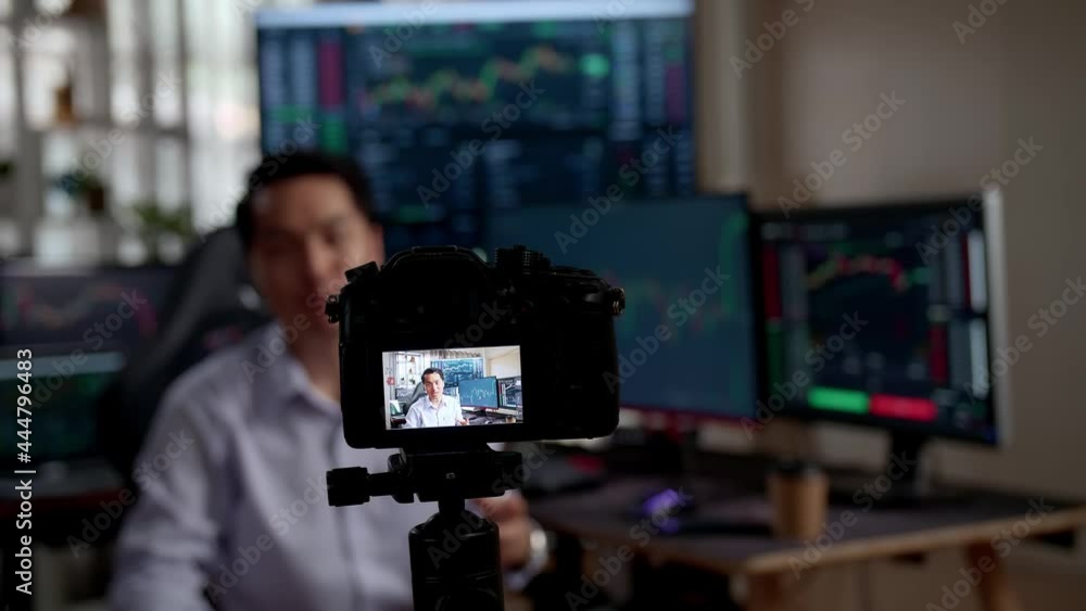 Camera Display With Asian Male Stock Market Broker Speaking, Analyzing Graphs On Multiple ...
