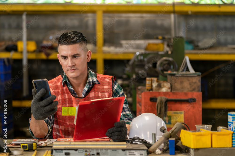 Portrait of Thoughtful Caucasian worker holding a clipboard and used ...