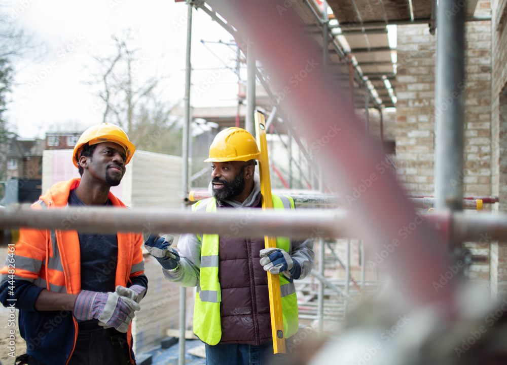 Construction workers talking at construction site Stock Photo | Adobe Stock