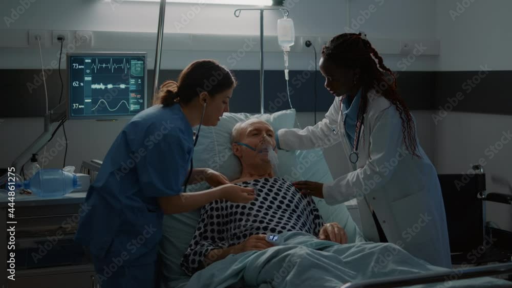 Patient with breathing problems fainting in hospital ward bed at modern ...