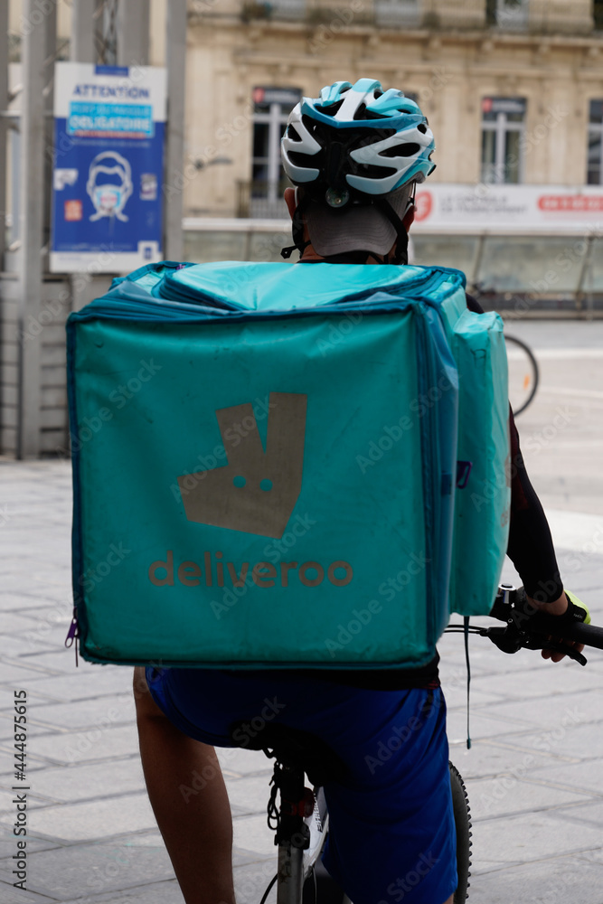 Deliveroo logo brand and text sign cargo box deliver man on bike ...