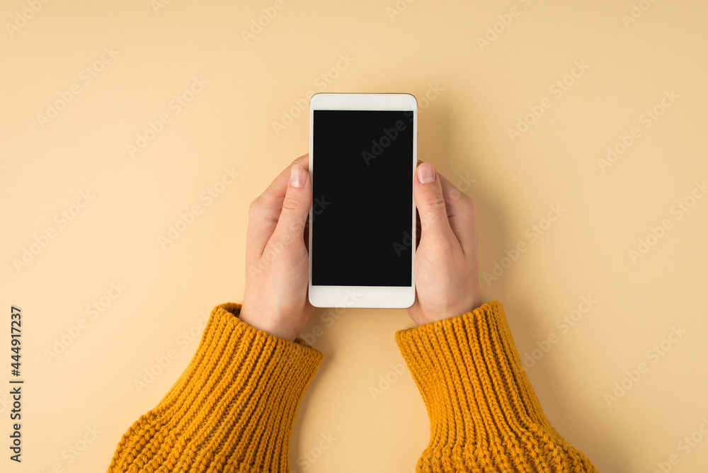 First person top view photo of female hands in yellow sweater holding ...