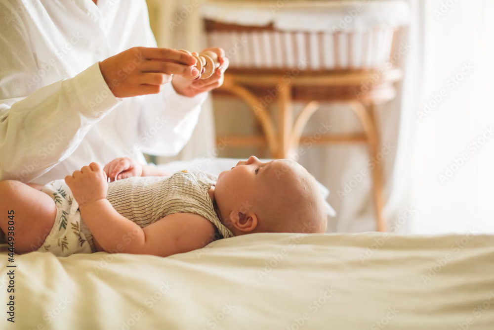 Doctor nurse with a toy with a baby, examination of a baby at home ...