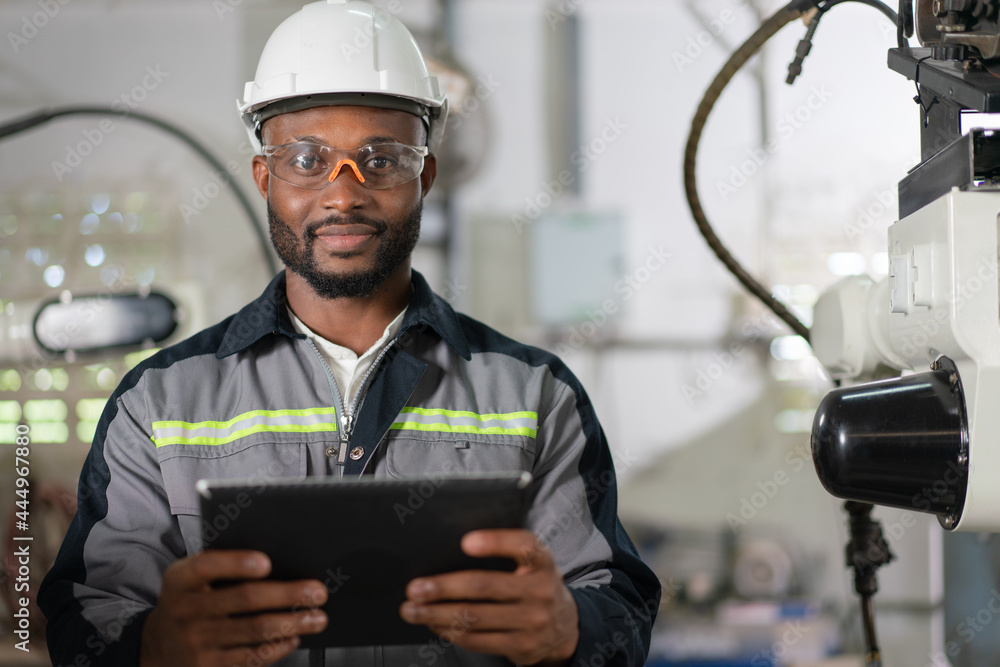 Portrait of male automation engineer hold tablet for inspection robot ...
