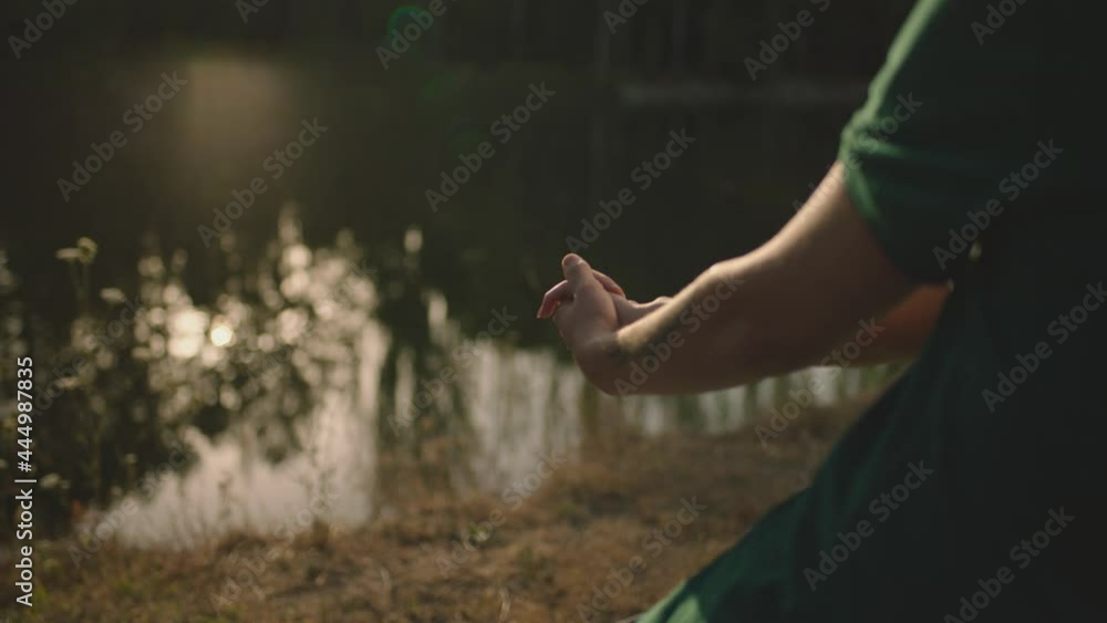 Back rear view of young couple standing by the lake or sea looking at ...