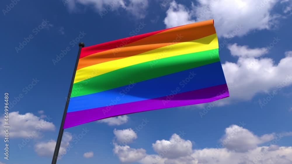 LGBTQ Pride Flag Waving. a LGBTQ pride flag waving in front of blue ...