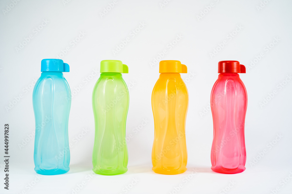 Four different colour of tupperware bottles Stock Photo | Adobe Stock