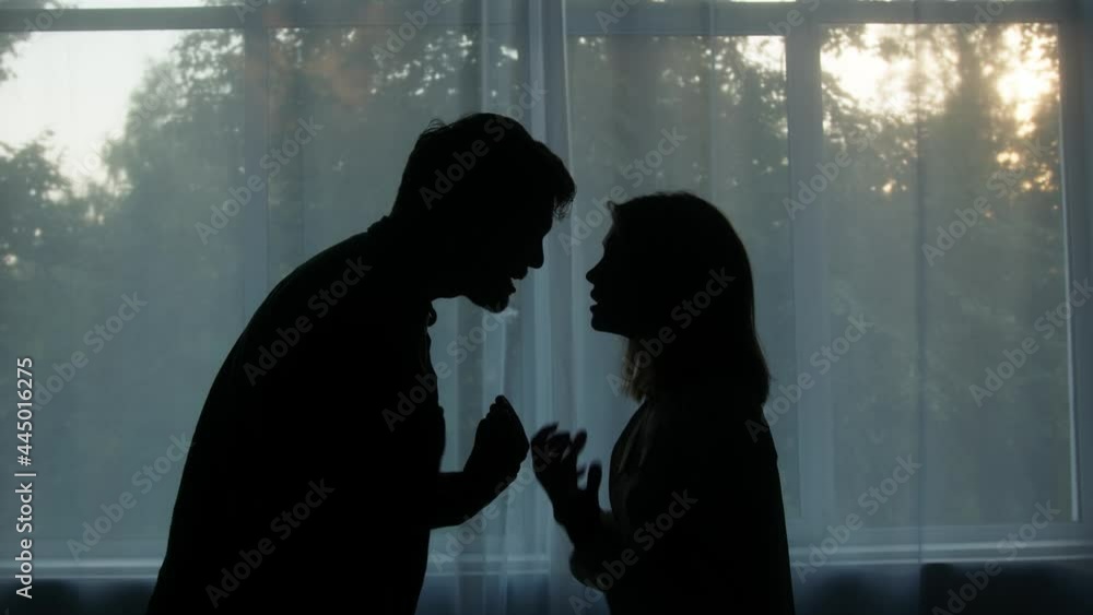 Silhouettes of man and woman shouting at each other, couple quarreling ...
