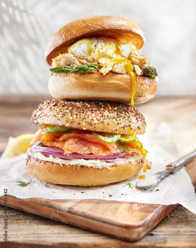 A stack of two bagels. Bottom is an everything bagel with lox, cream ...