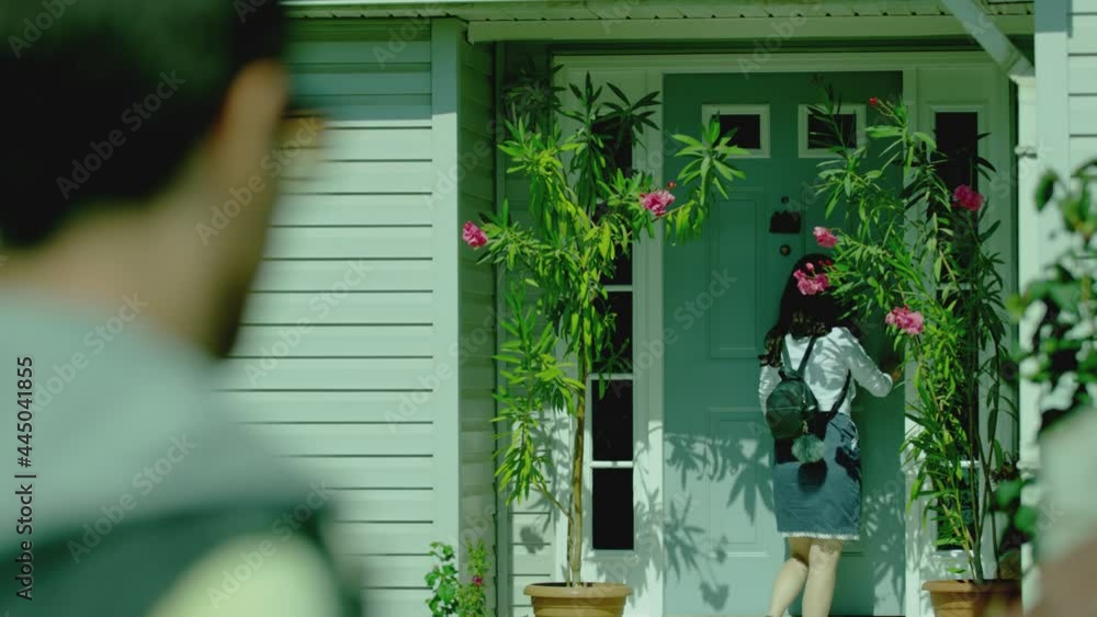 Back rear view stranger man following young girl while she walking on ...