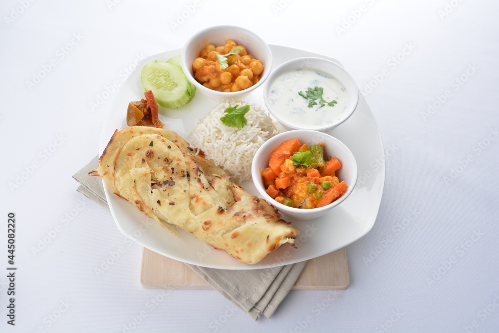 Indian baked roti prata canai with curry vegetables, yogurt sauce, pea ...