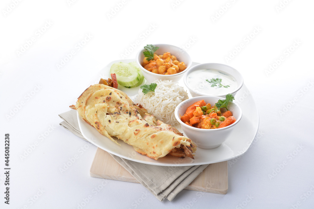 Indian baked roti prata canai with curry vegetables, yogurt sauce, pea ...