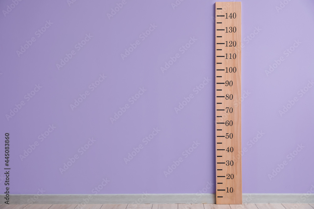 Big ruler for height measuring near color wall Stock Photo | Adobe Stock
