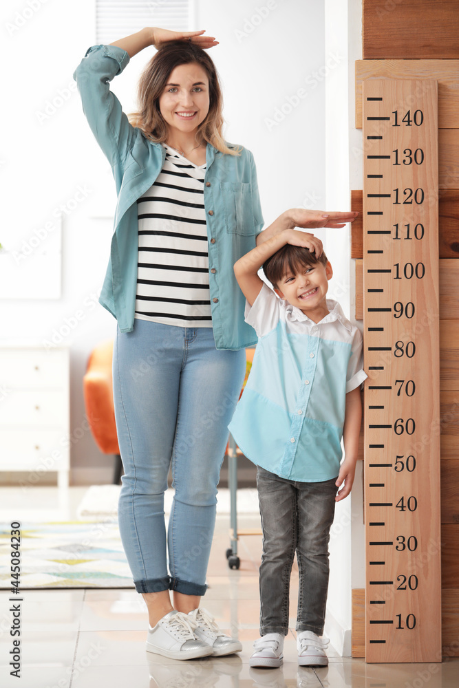 Little boy and his mother measuring height at home Stock Photo | Adobe ...