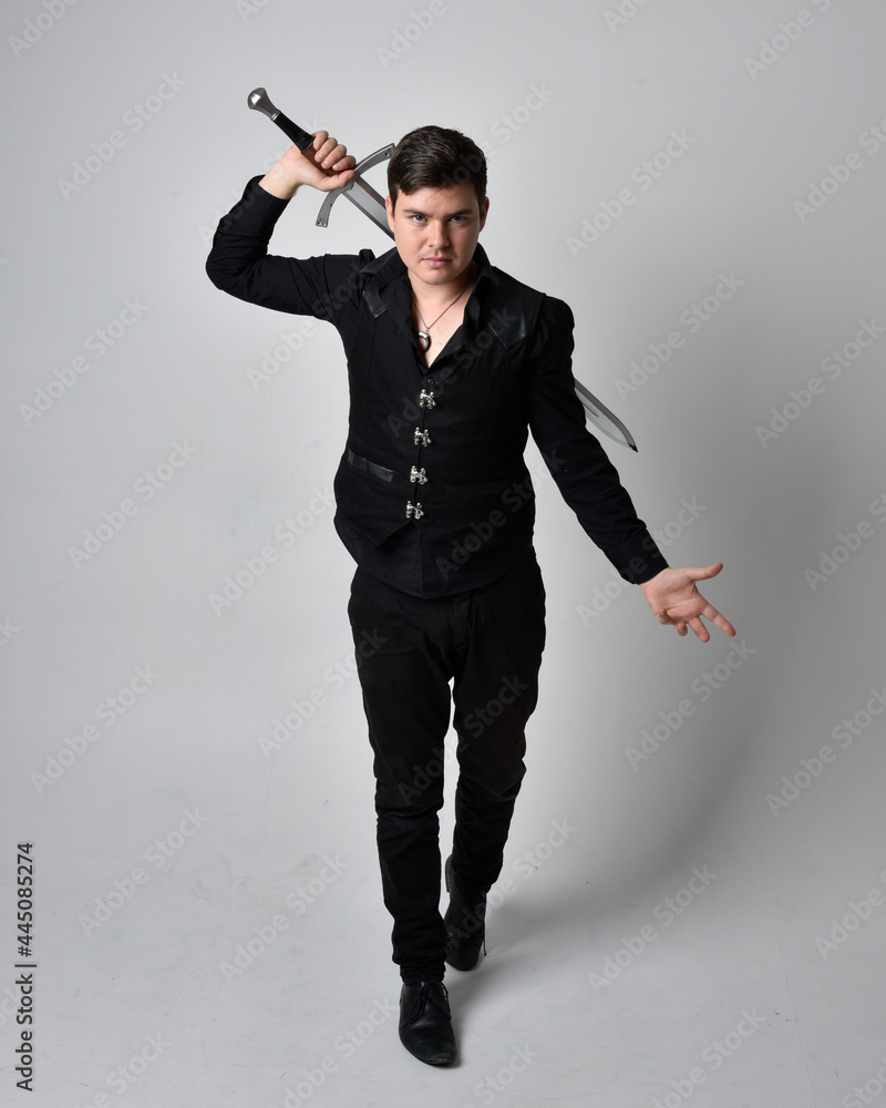 Full length portrait of a brunette man wearing black shirt and gothic ...